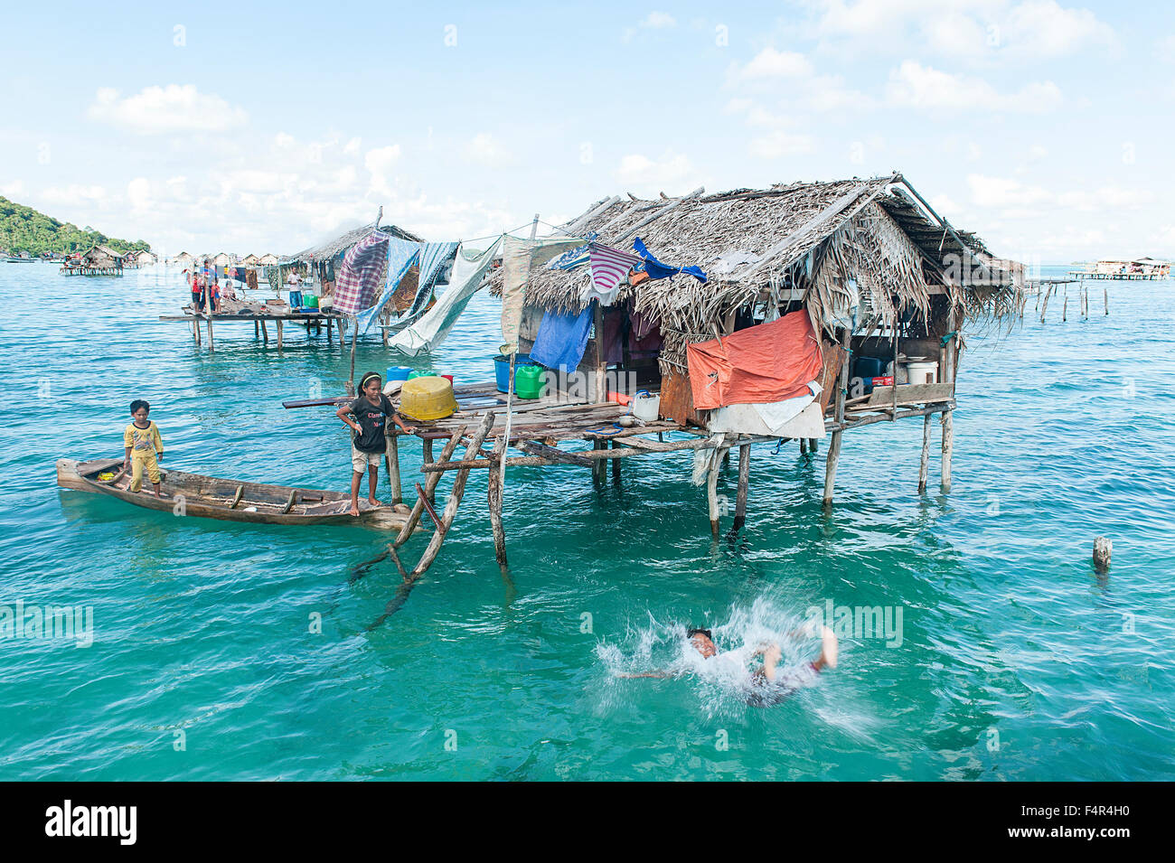 Unidentified Borneo Sea Gypsy peoples on a canoes in Mabul Maiga Island ...