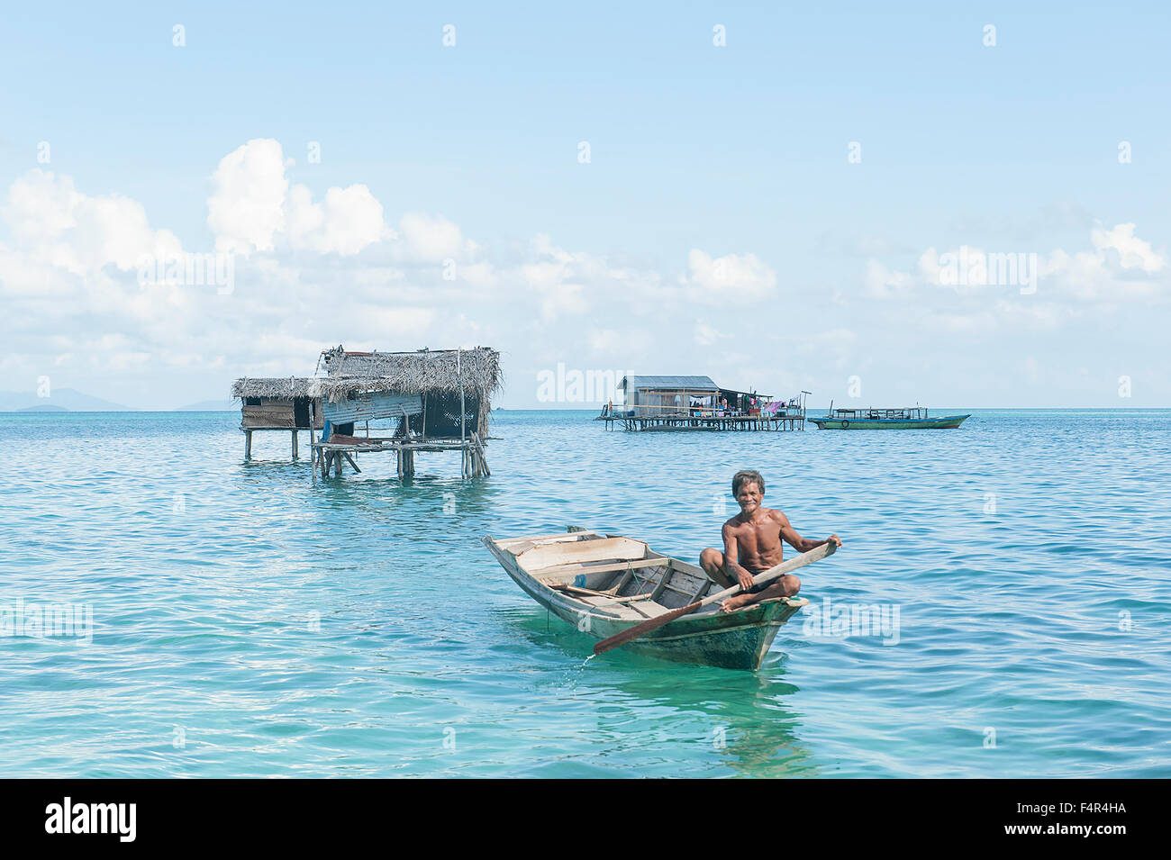Unidentified Borneo Sea Gypsy peoples on a canoes in Mabul Maiga Island ...