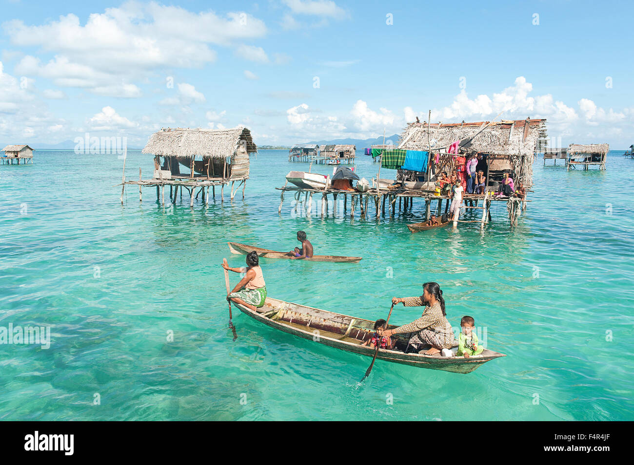 Unidentified Borneo Sea Gypsy peoples on a canoes in Mabul Maiga Island ...