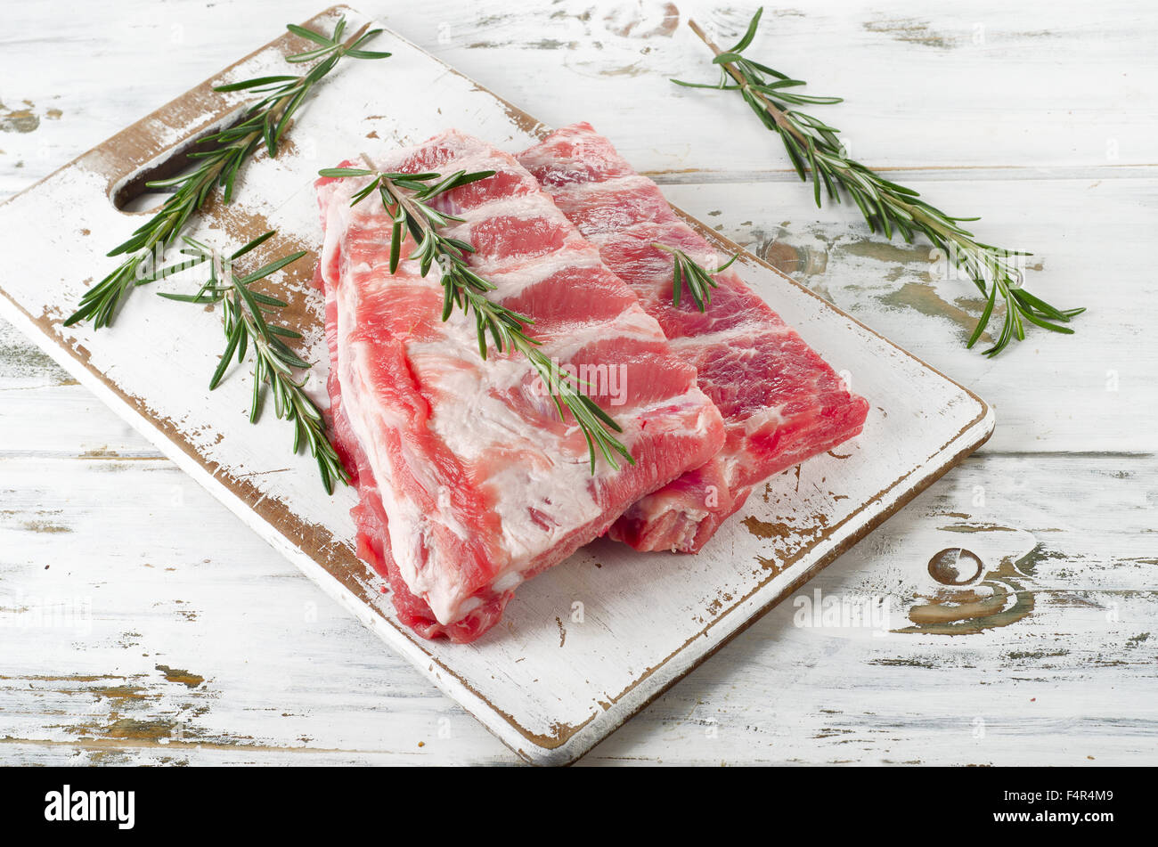 Raw spare ribs with fresh rosemary. Top view Stock Photo - Alamy