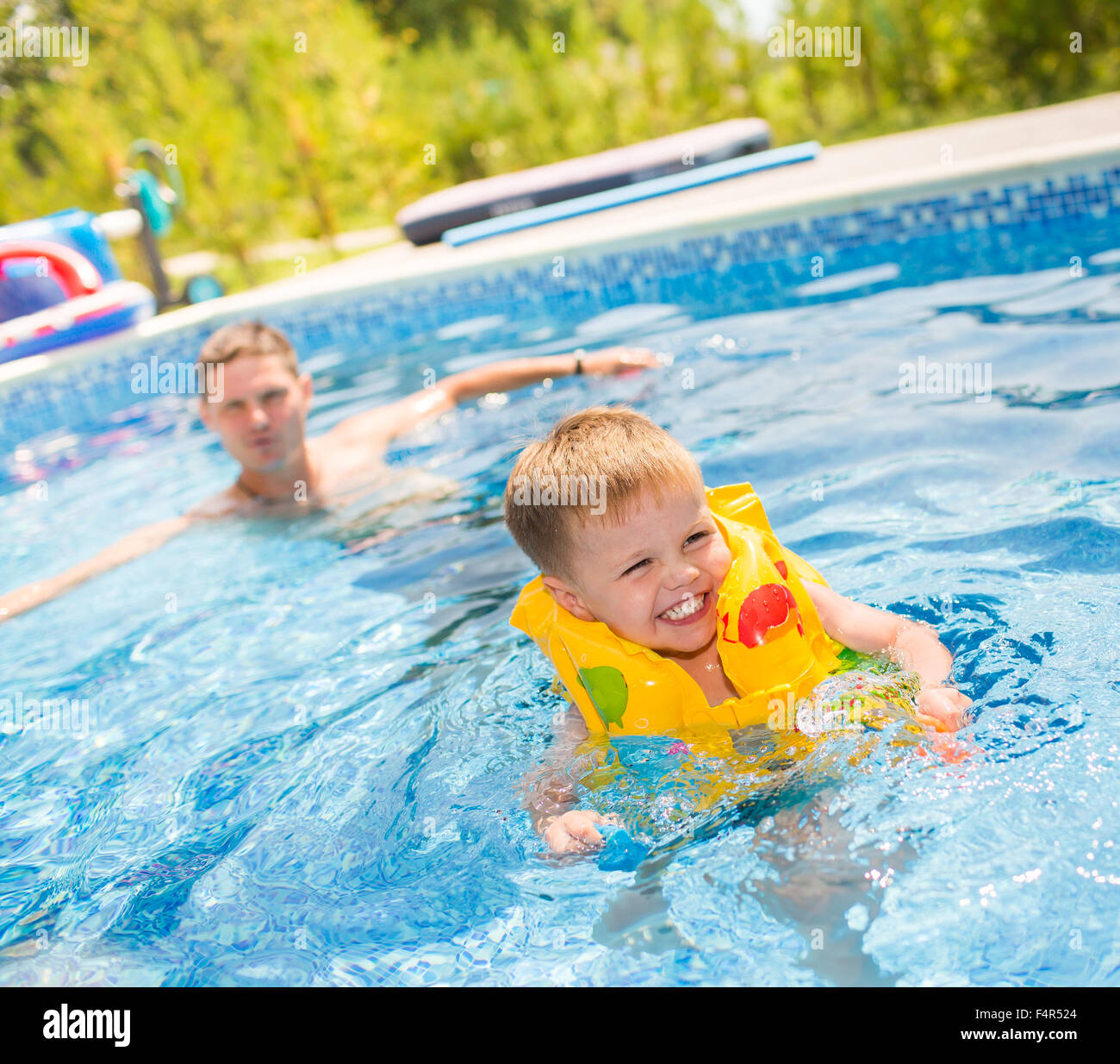Child playing in swimming pool Stock Photo - Alamy