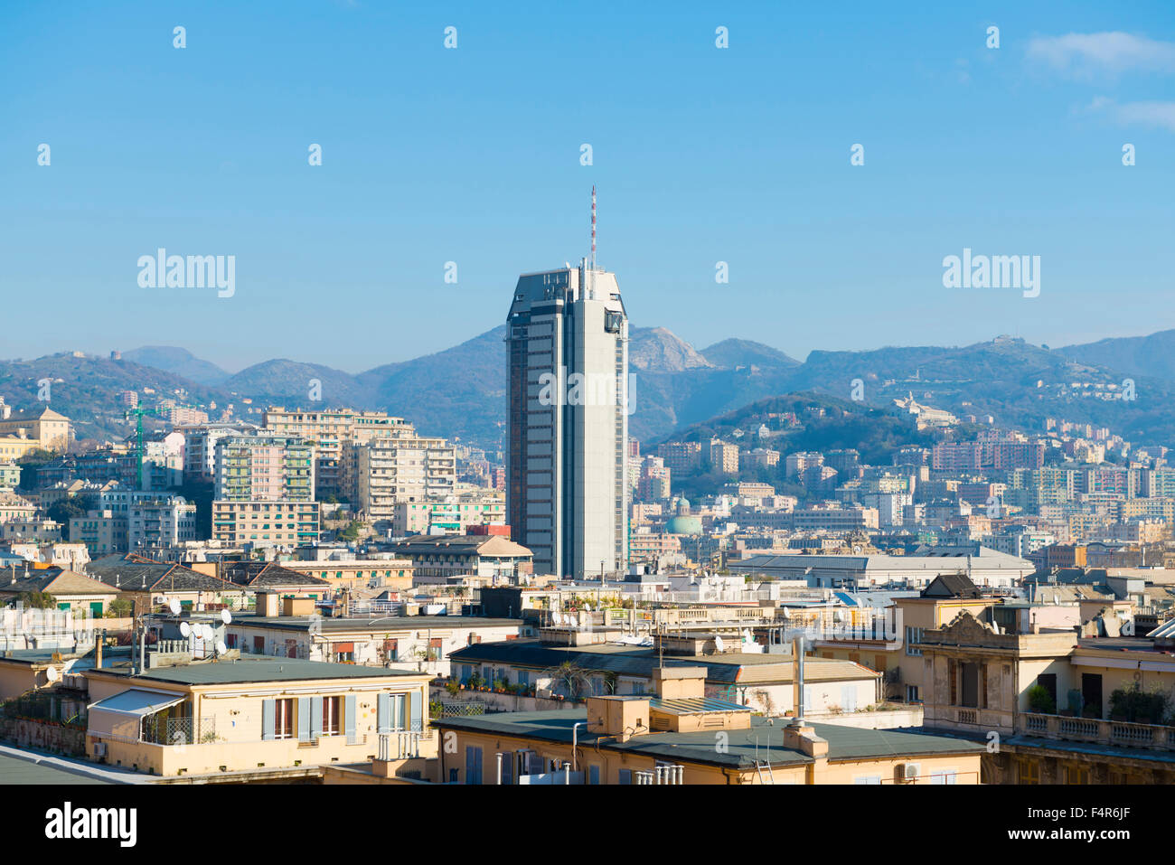 Skyscraper and buildings with mountains in a sunny day in Genoa, Italy ...