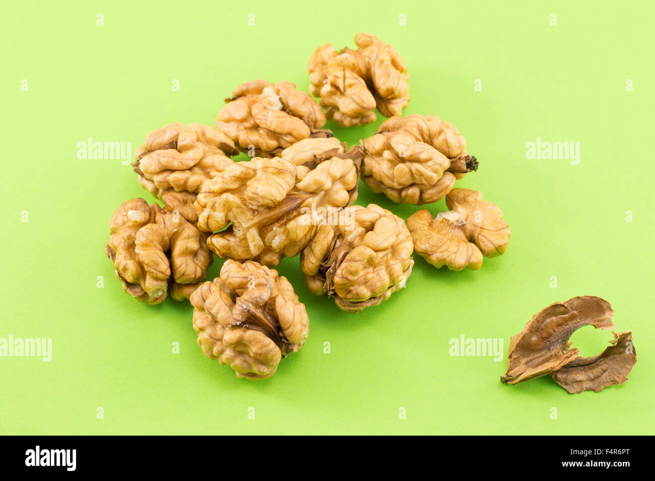 Whole peeled walnuts placed on green background Stock Photo - Alamy