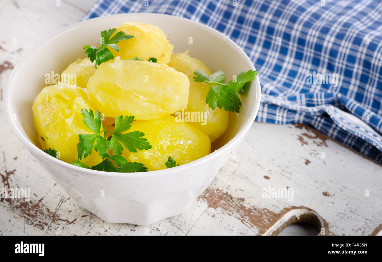 Boiled potatoes with parsley in a white bowl. Selective focus Stock ...