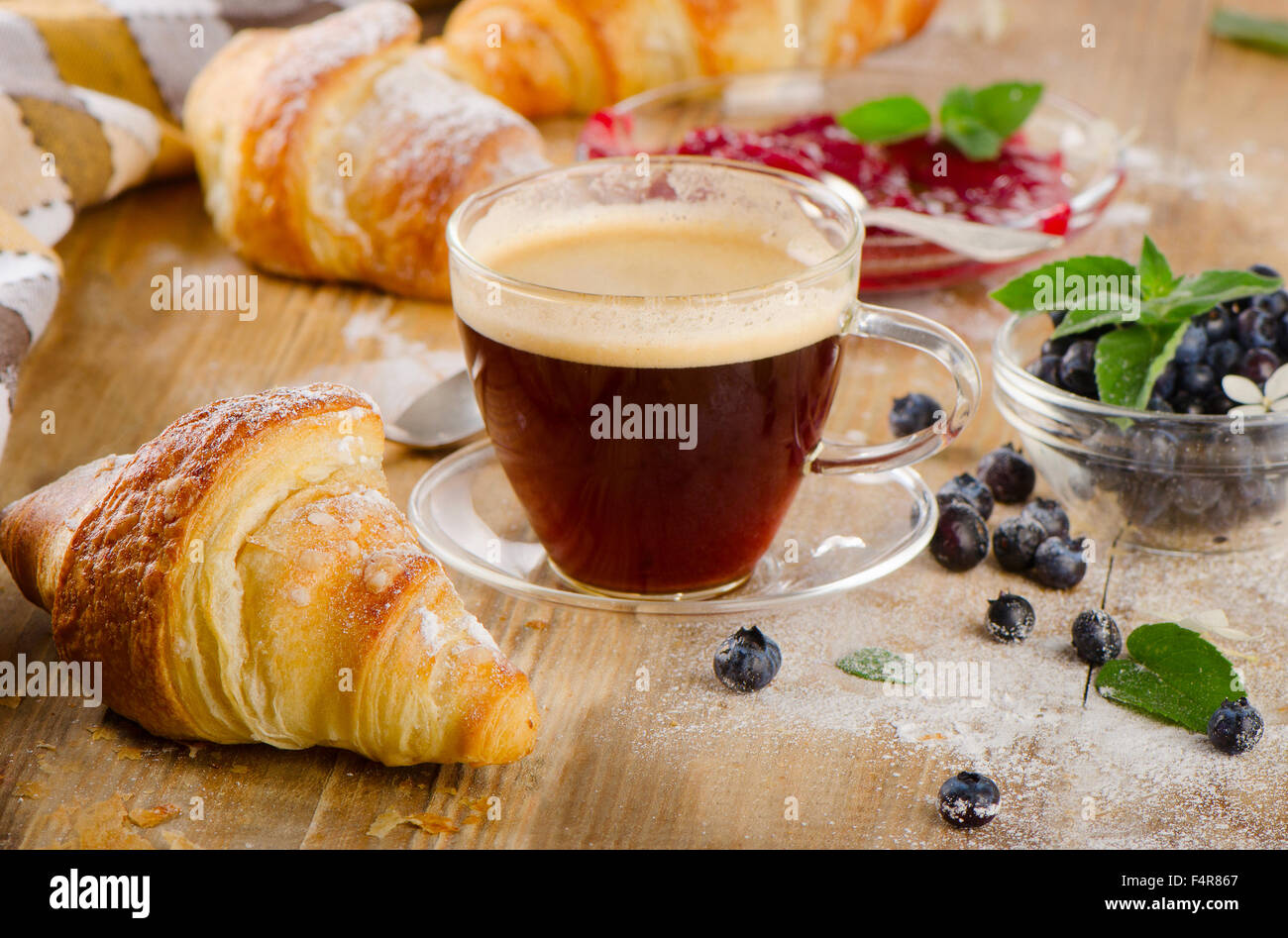 Coffee and fresh croissants for breakfast on rustic wooden table. Selective focus Stock Photo ...