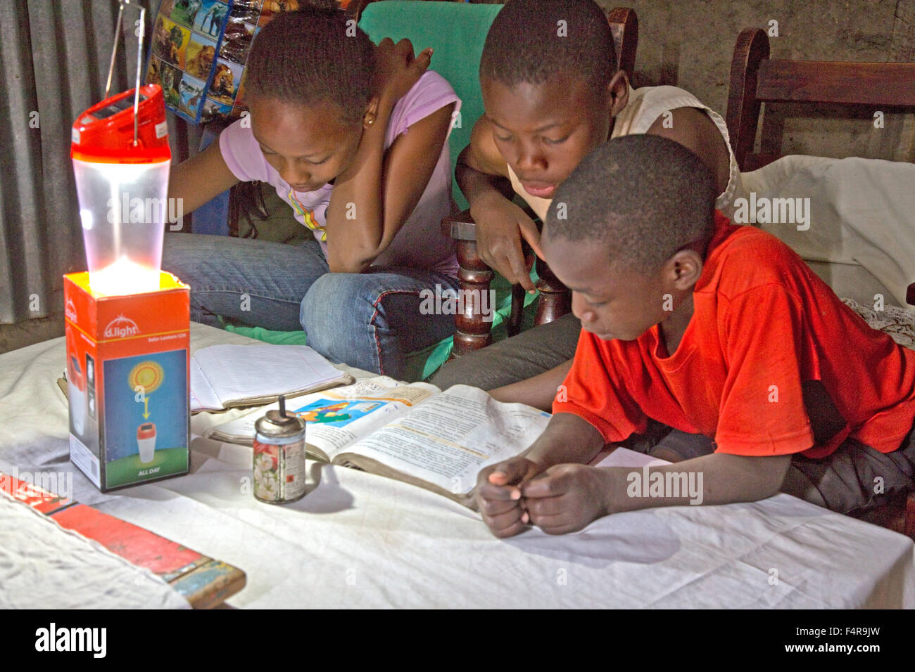 African children studying school book with solar powered light Kamere ...