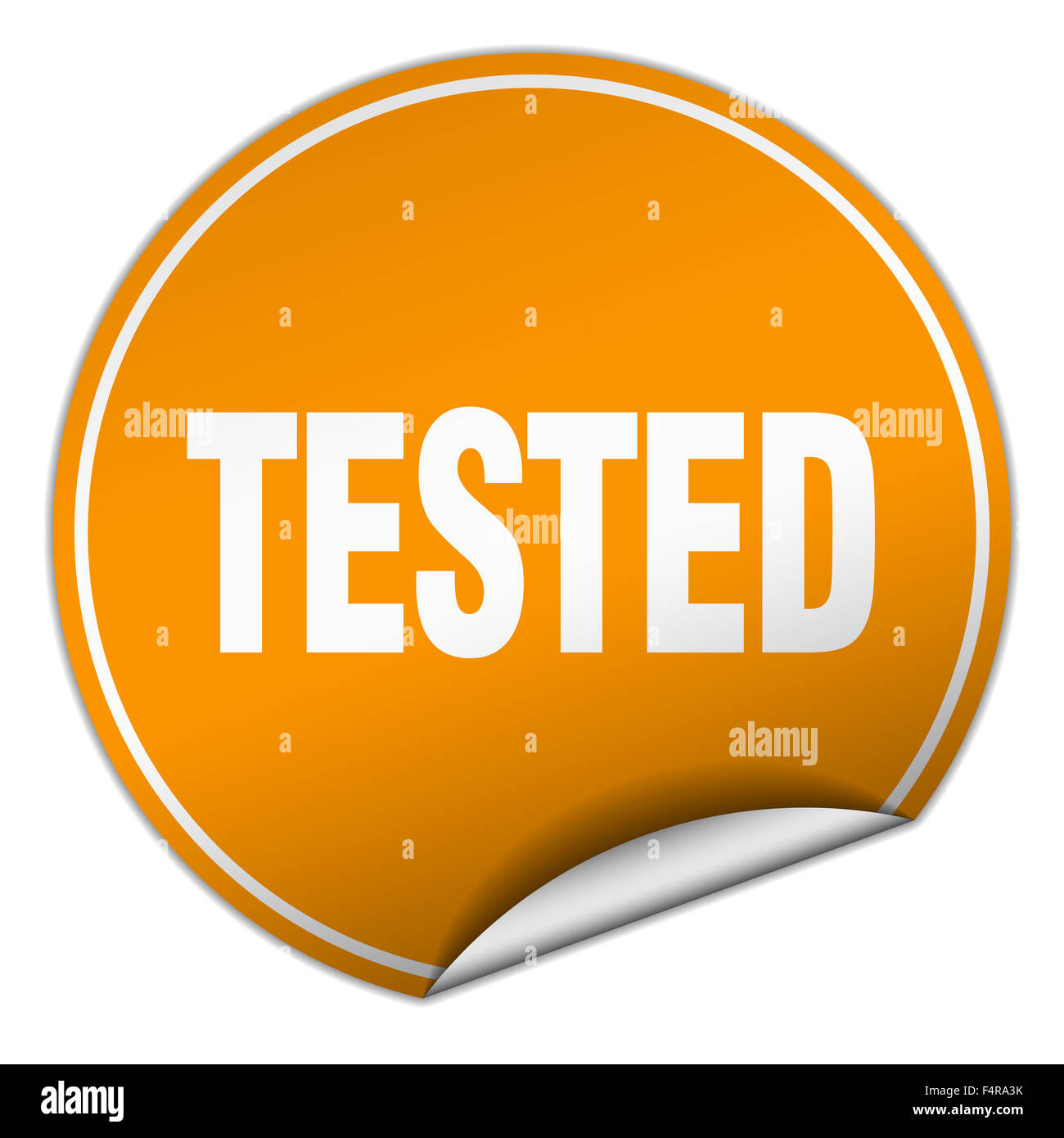 tested round orange sticker isolated on white Stock Photo - Alamy