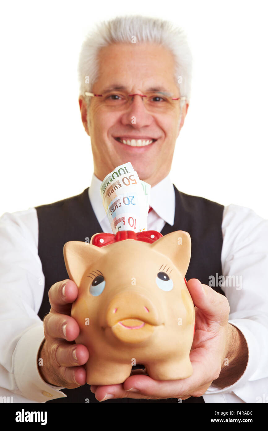 Happy senior citizen holding a piggy bank Stock Photo - Alamy