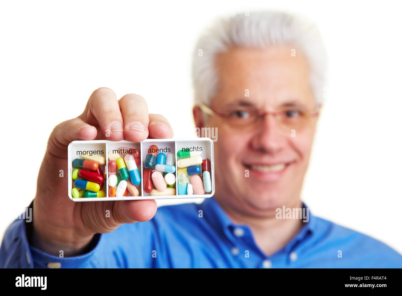 Senior citizen holding a german pill box Stock Photo - Alamy