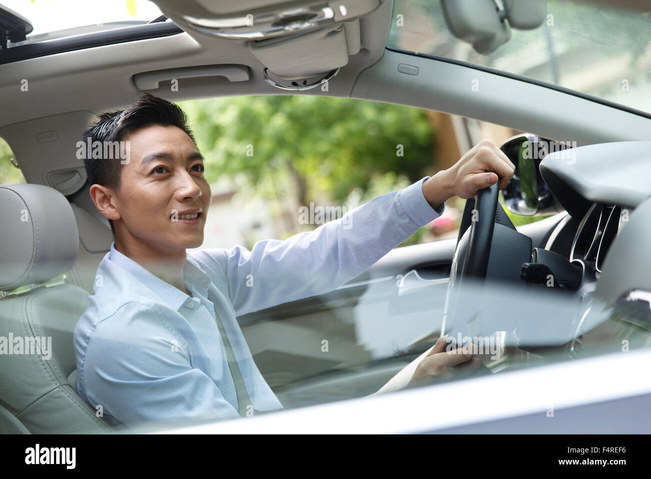 Young chinese man driving car hi-res stock photography and images - Alamy