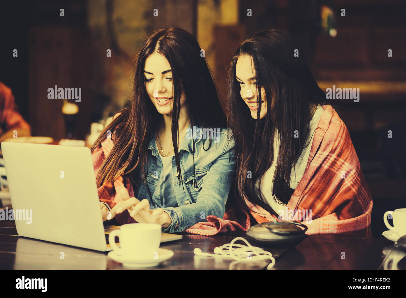 two girls watching something in laptop Stock Photo - Alamy