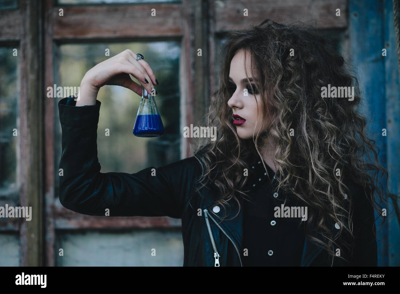 Vintage witch with elixir in hand Stock Photo - Alamy