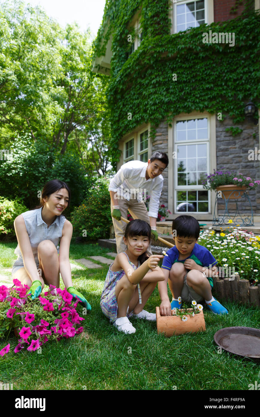 Happy family in the garden Stock Photo - Alamy