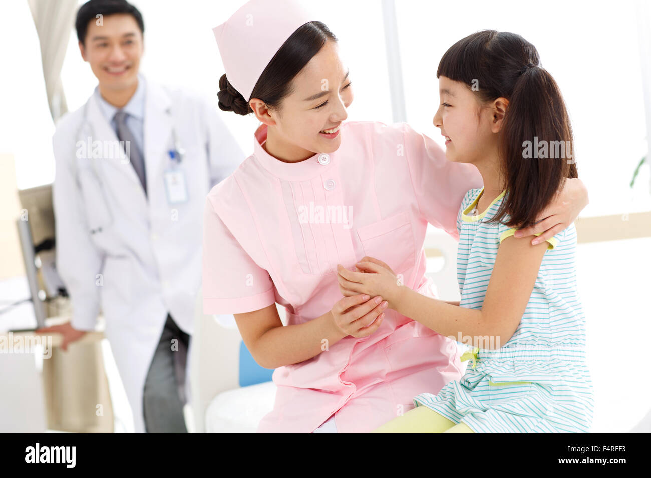 Health care workers and girls Stock Photo - Alamy