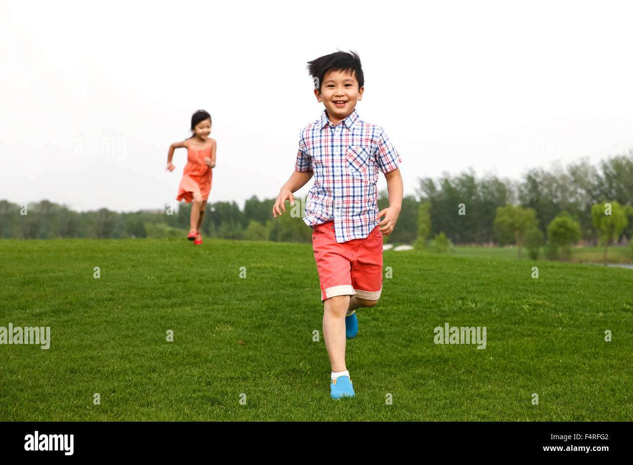 Lovely children running outdoors Stock Photo - Alamy