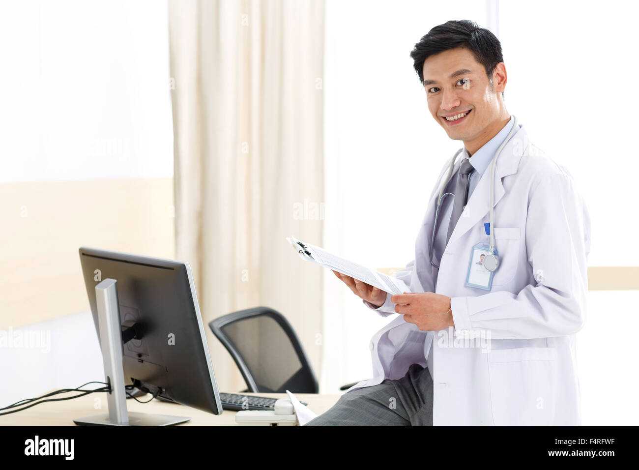 A doctor with a medical record card Stock Photo - Alamy