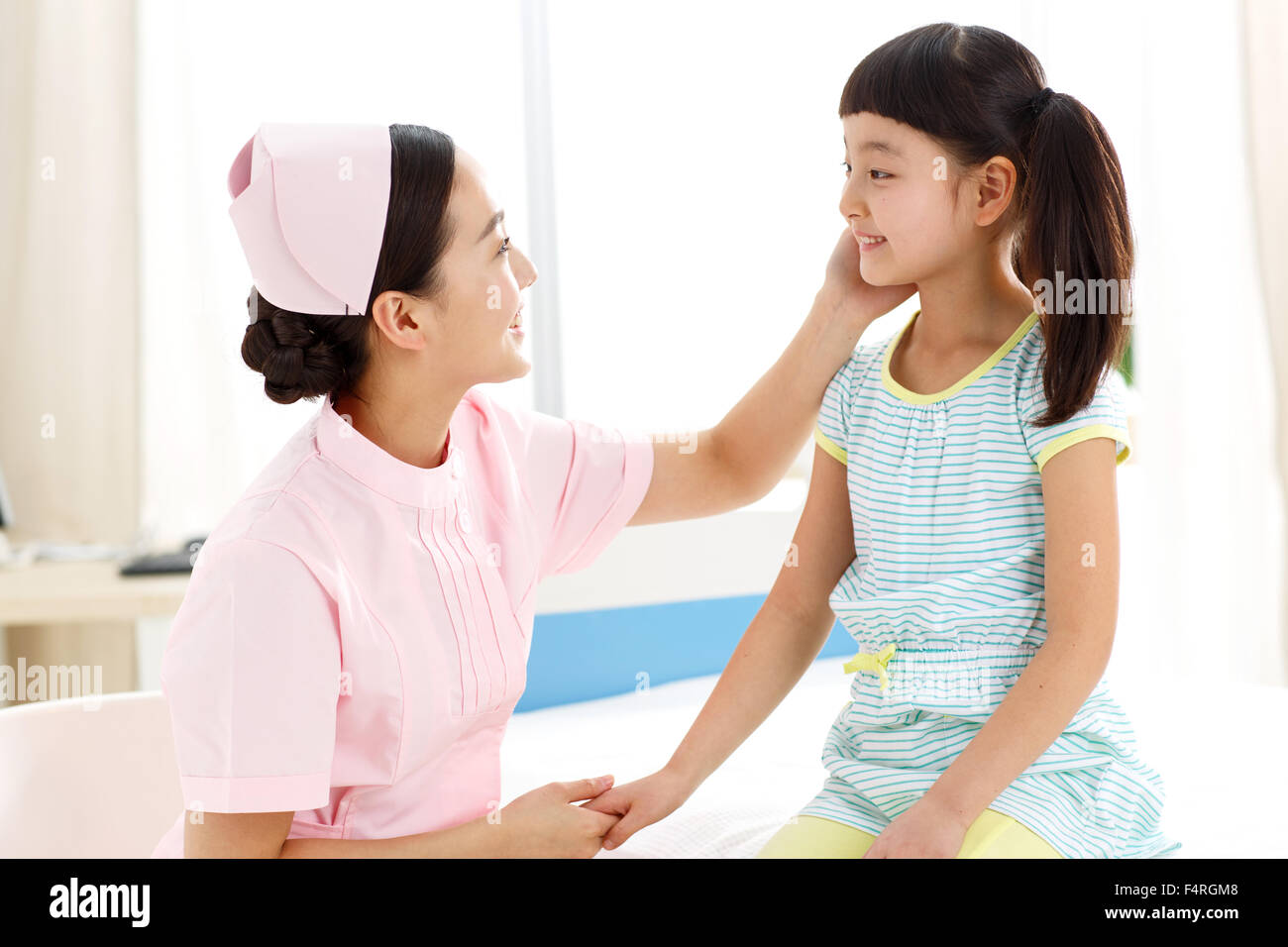 Health care workers and girls Stock Photo - Alamy