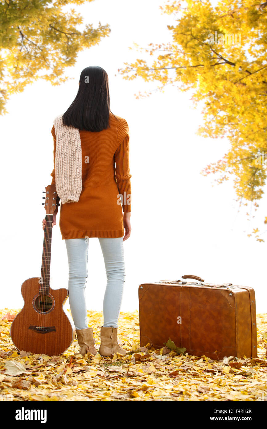 Young woman sitting in the trunk Stock Photo - Alamy