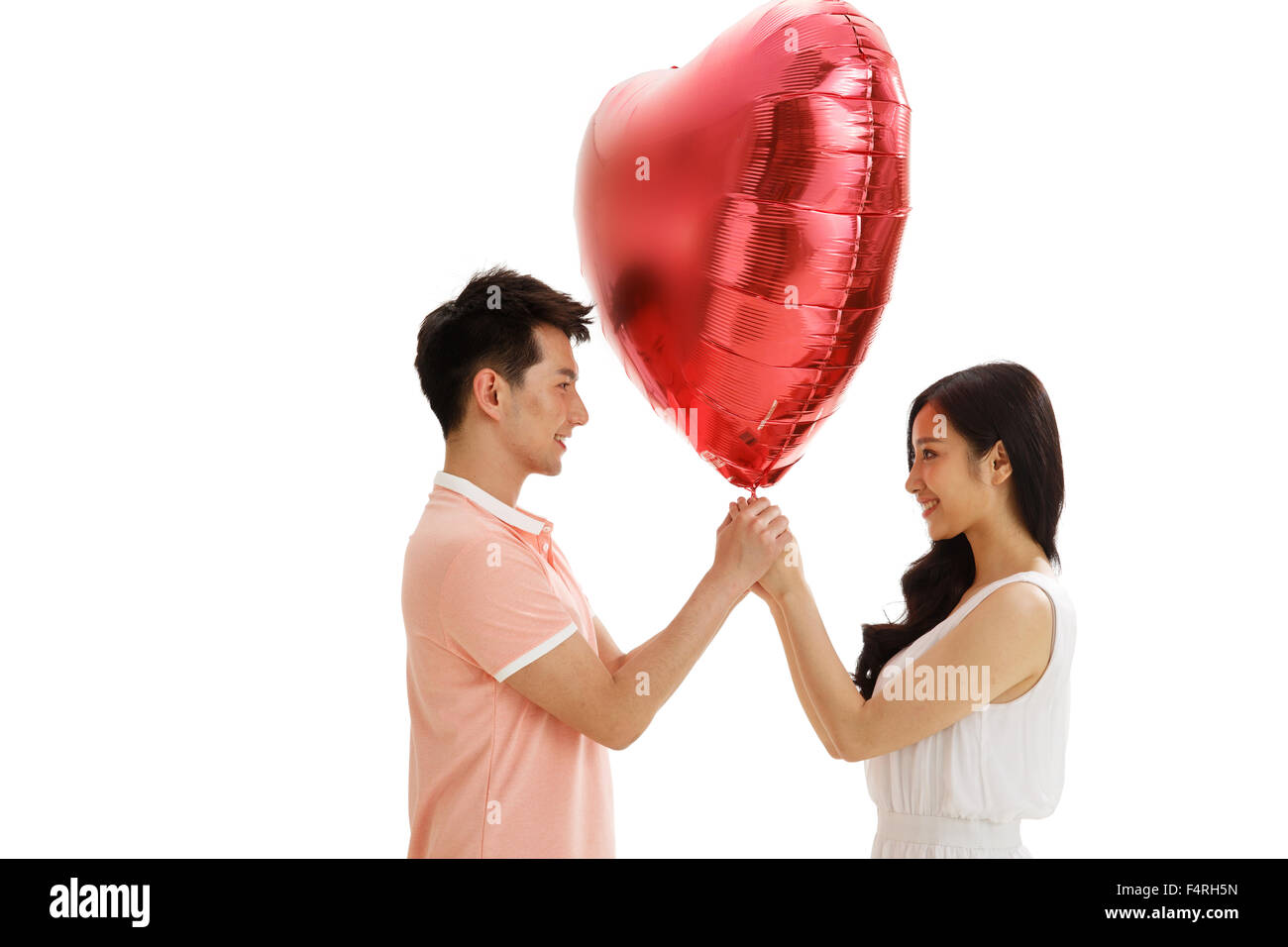 Happy couples holding a balloon Stock Photo - Alamy