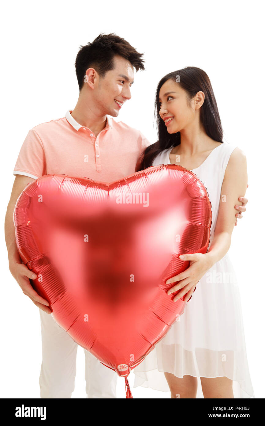 Happy couples holding a balloon Stock Photo - Alamy