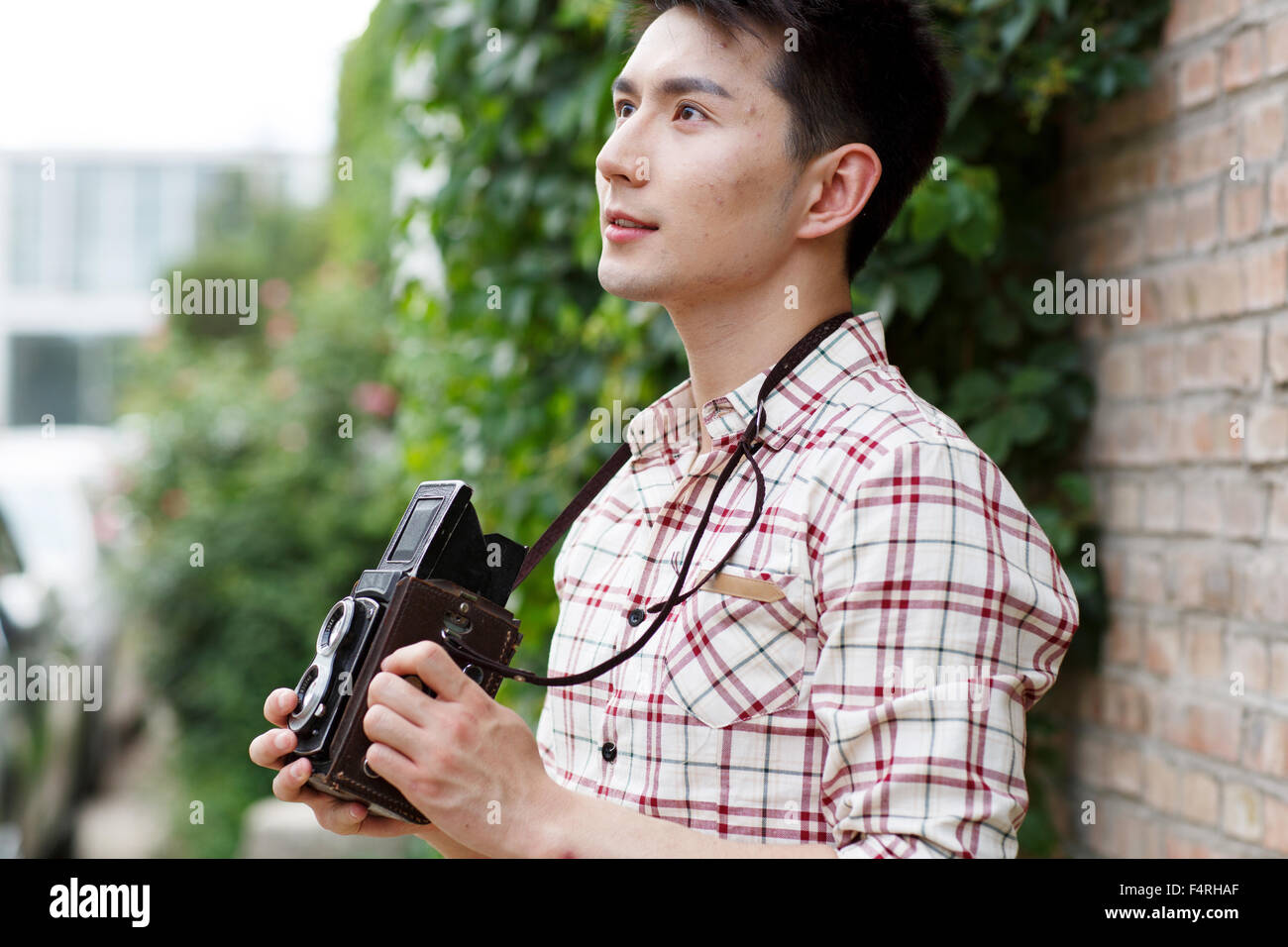 Young man with a camera Stock Photo - Alamy
