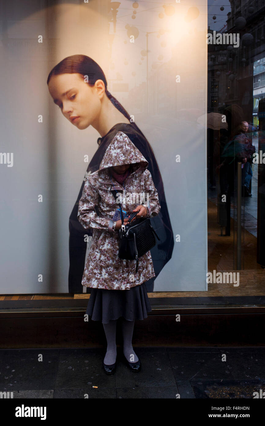 Model on an Adidas seemingly looks over her shoulder to watch a woman ...