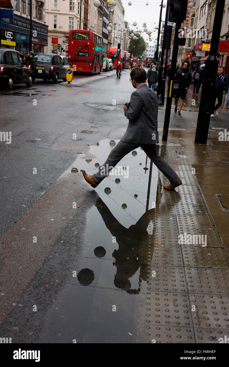 Man steps into a puddle High Resolution Stock Photography and Images ...