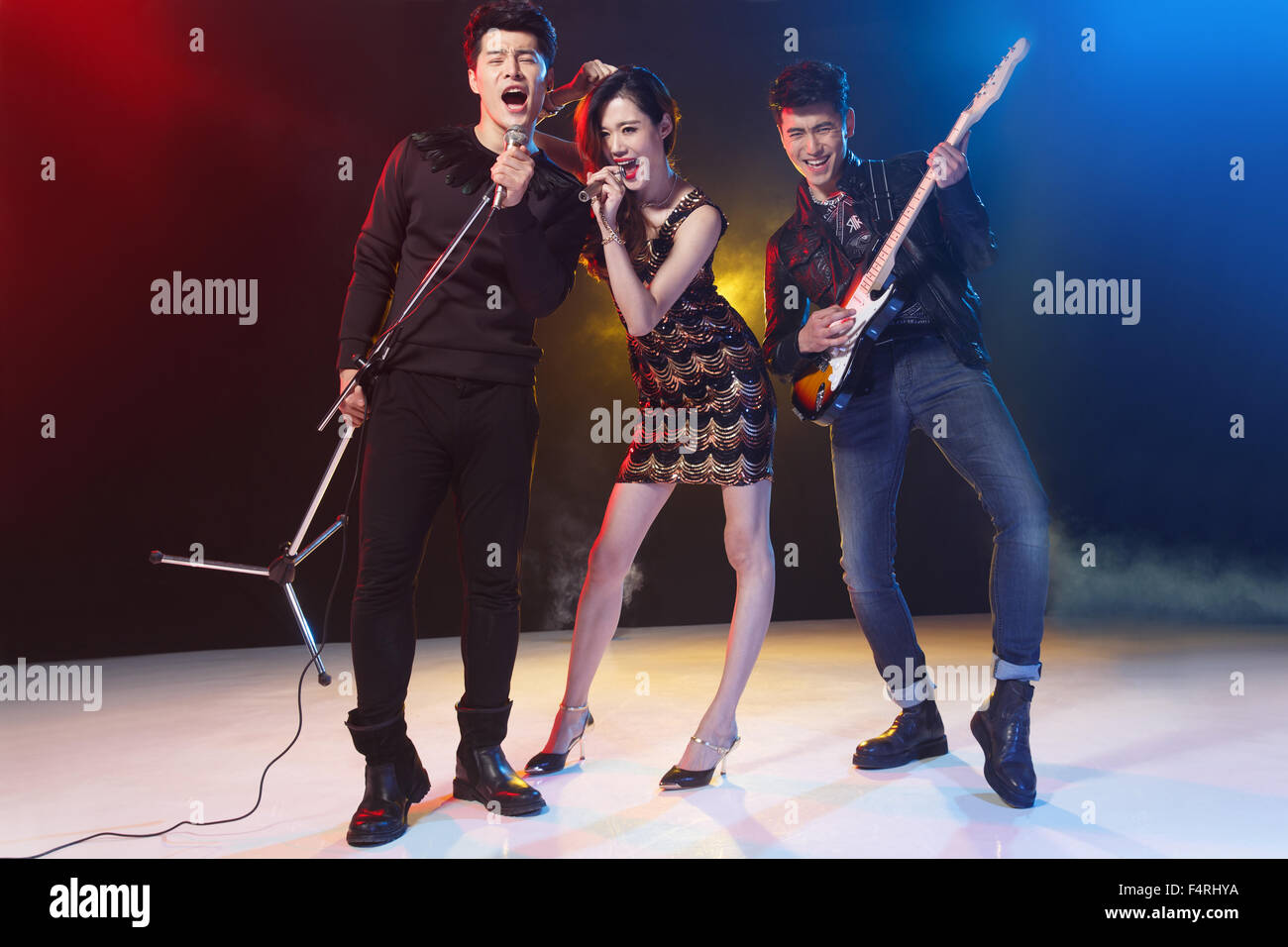 Young men and women singing in the dance hall Stock Photo - Alamy