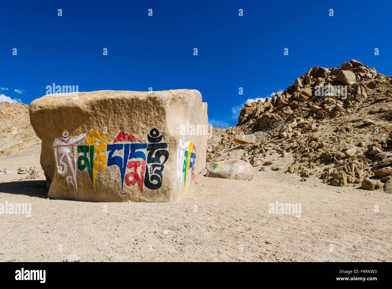 A big tibetean Mani Stone with the Mantra Om Mani Padme Hum colorfully ...