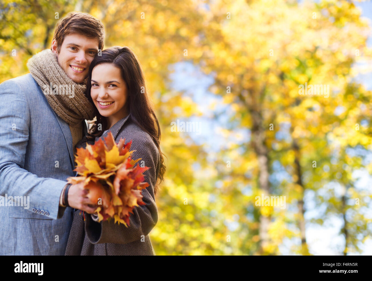 smiling couple hugging over autumn background Stock Photo - Alamy