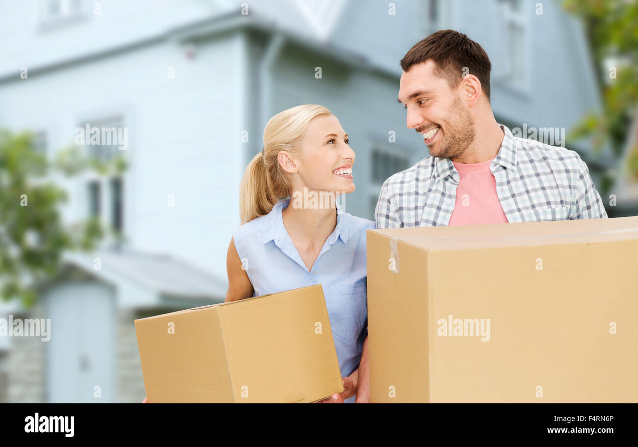 couple with cardboard boxes moving to new home Stock Photo - Alamy