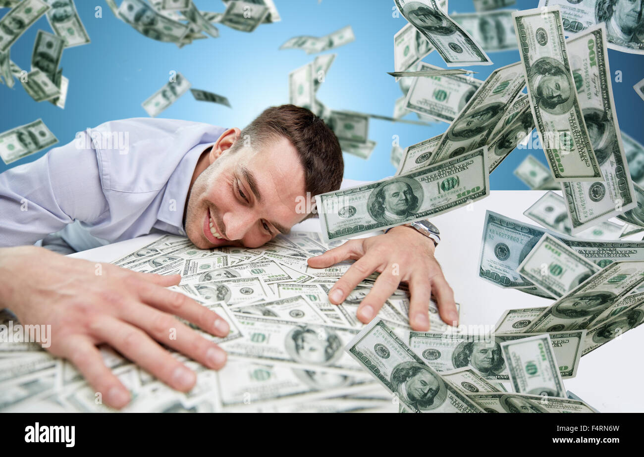 happy businessman with heap of money Stock Photo - Alamy