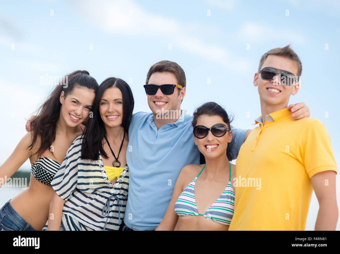 group of happy friends hugging on beach Stock Photo - Alamy