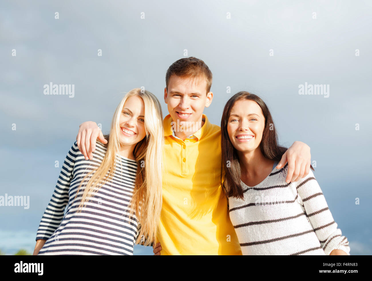 Group of friends hugging at the beach hi-res stock photography and ...