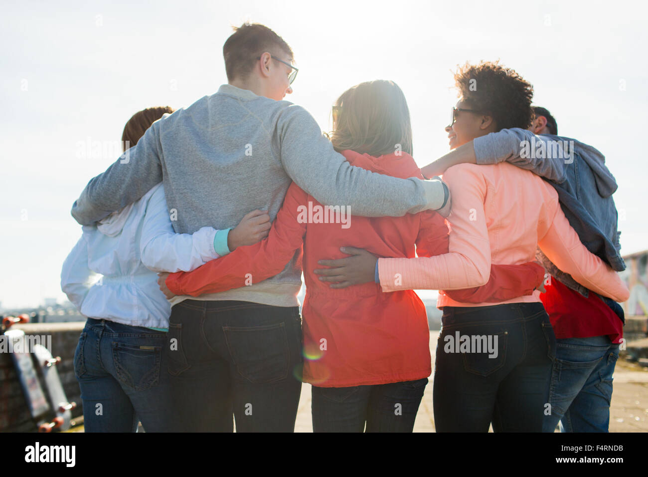 group of happy teenage friends hugging on street Stock Photo - Alamy