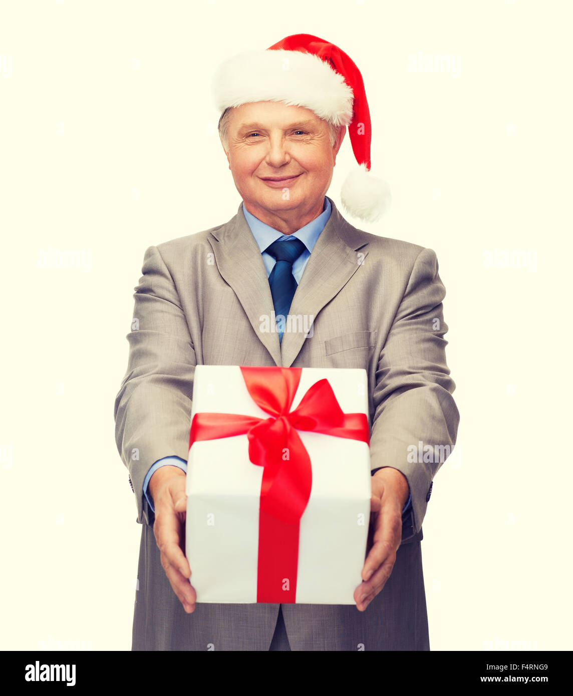 smiling man in suit and santa helper hat with gift Stock Photo - Alamy