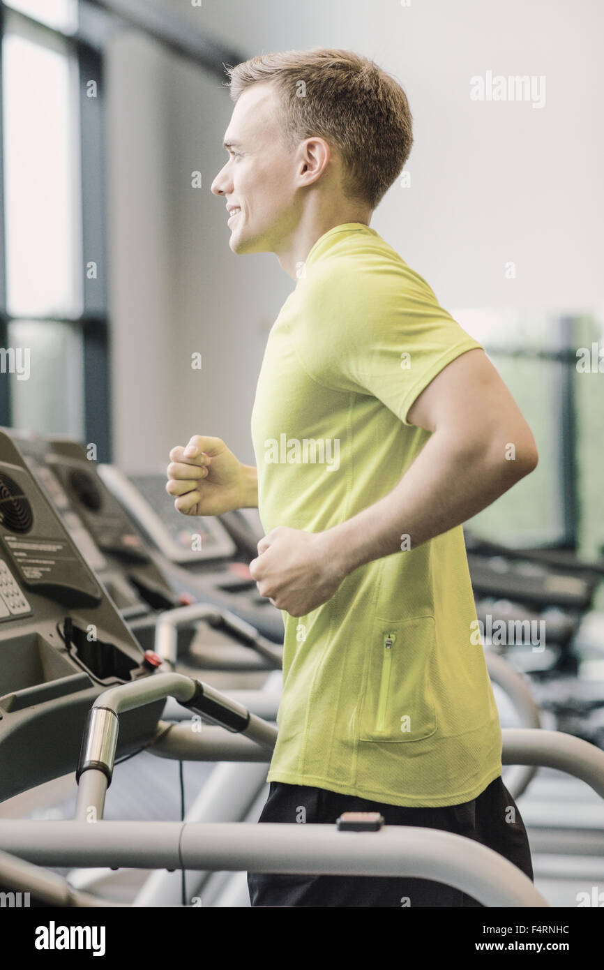smiling man exercising on treadmill in gym Stock Photo - Alamy
