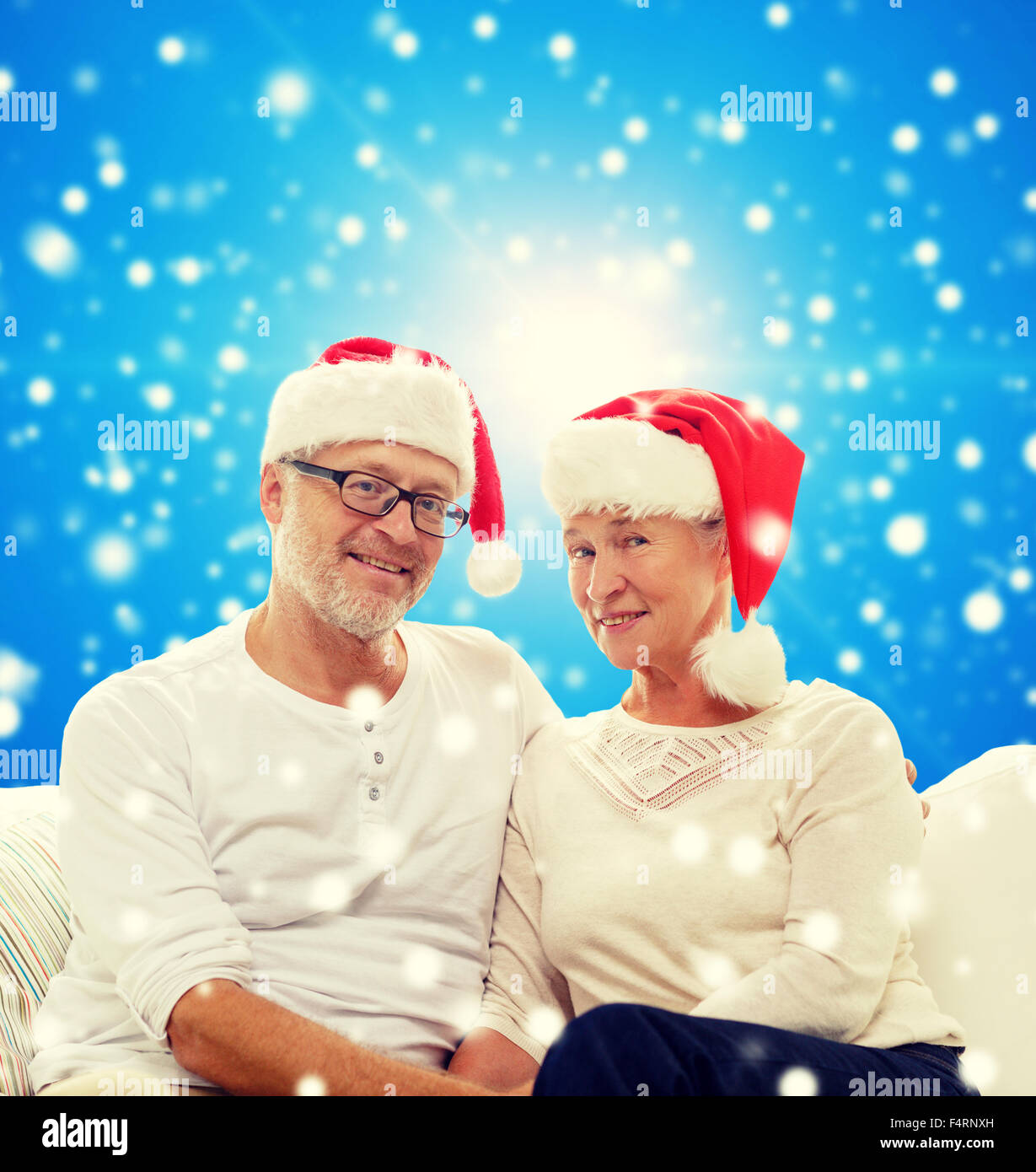 happy senior couple in santa helper hats Stock Photo - Alamy