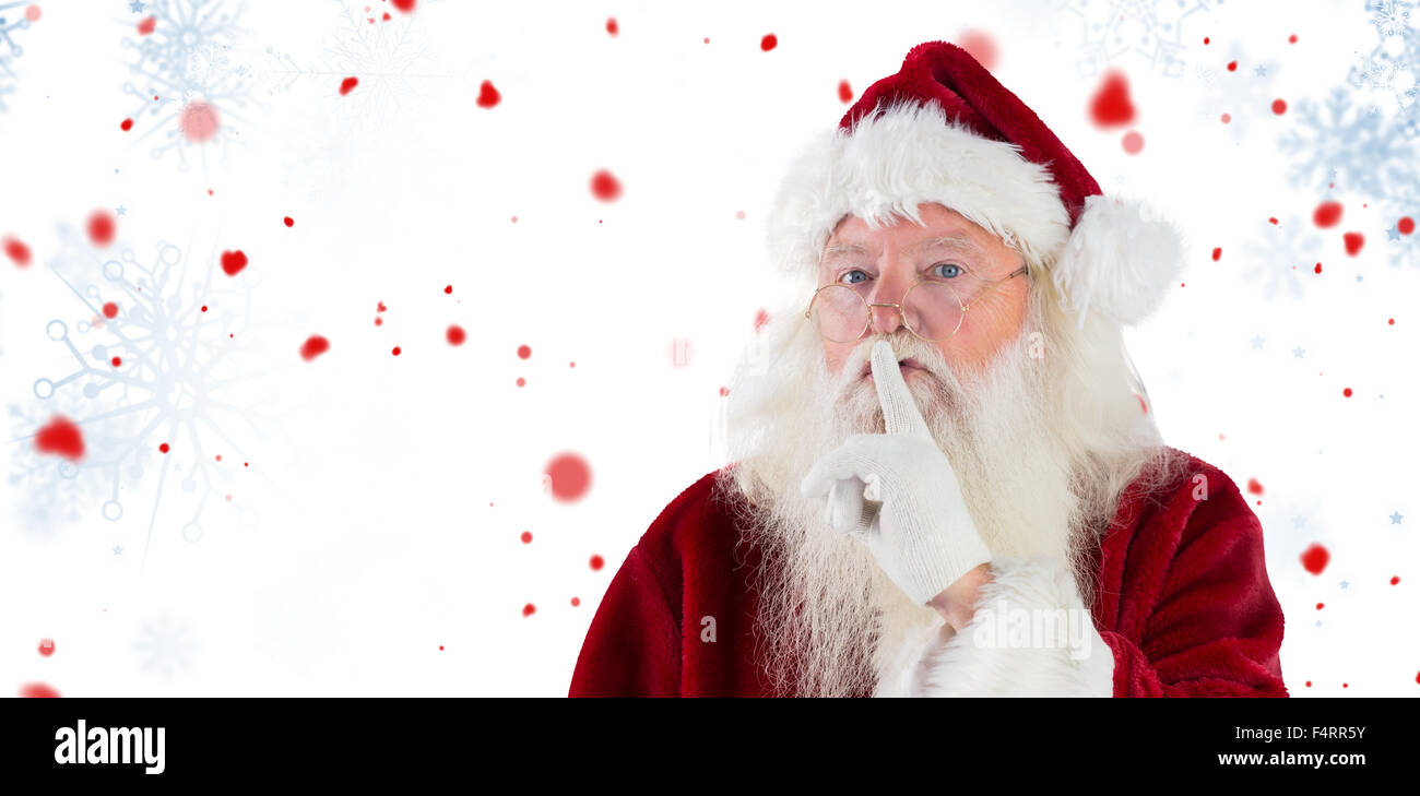 Composite image of santa asking for quiet to camera Stock Photo - Alamy