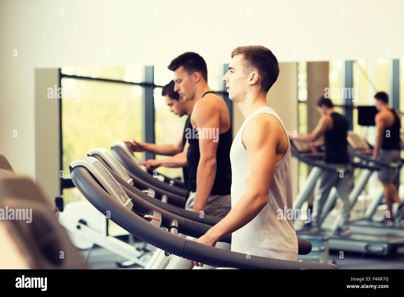group of men exercising on treadmill in gym Stock Photo - Alamy
