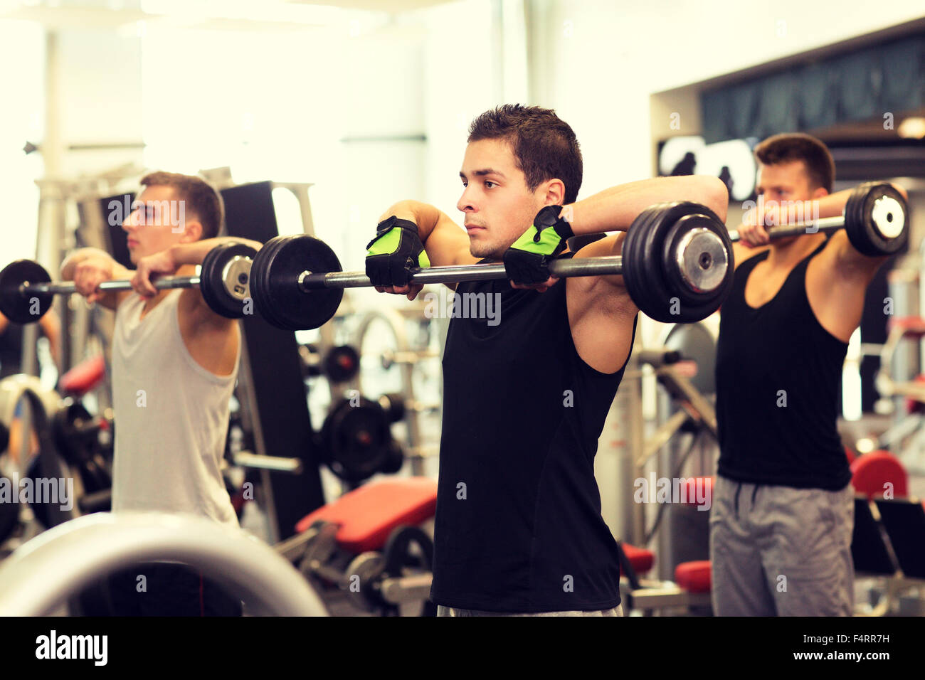 group of men with barbells in gym Stock Photo - Alamy