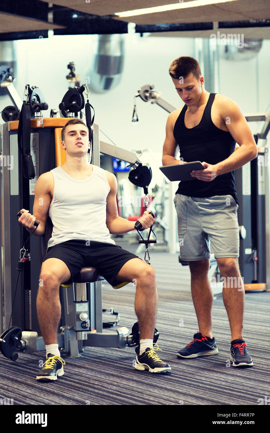 man exercising on gym machine Stock Photo - Alamy