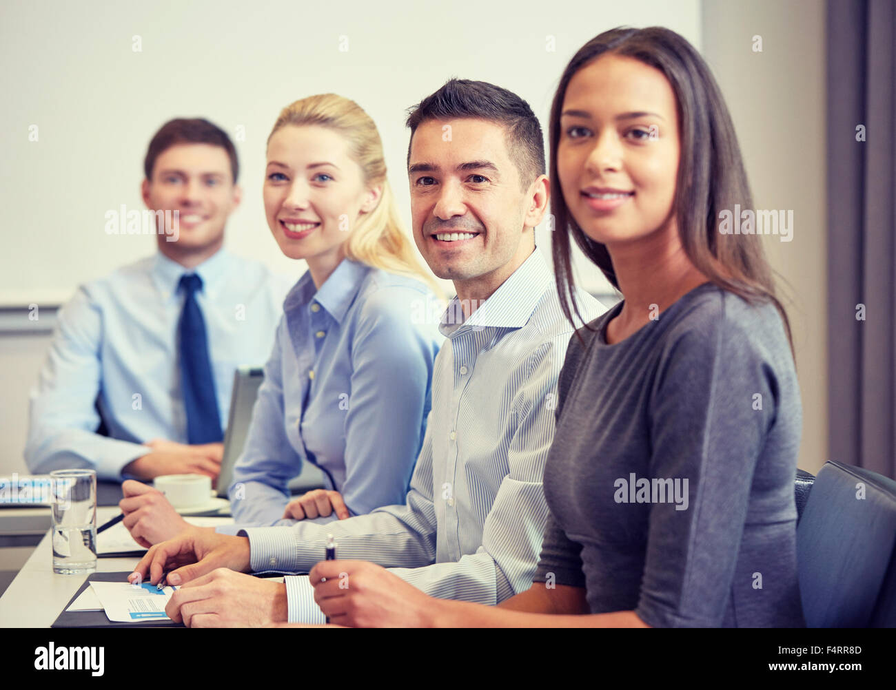 group of smiling businesspeople meeting in office Stock Photo - Alamy