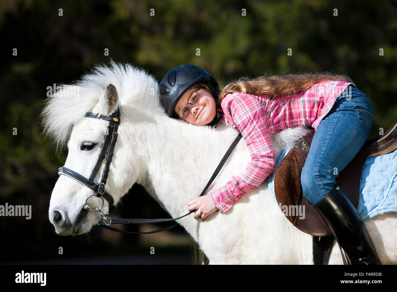 Girl cuddling pony hi-res stock photography and images - Alamy