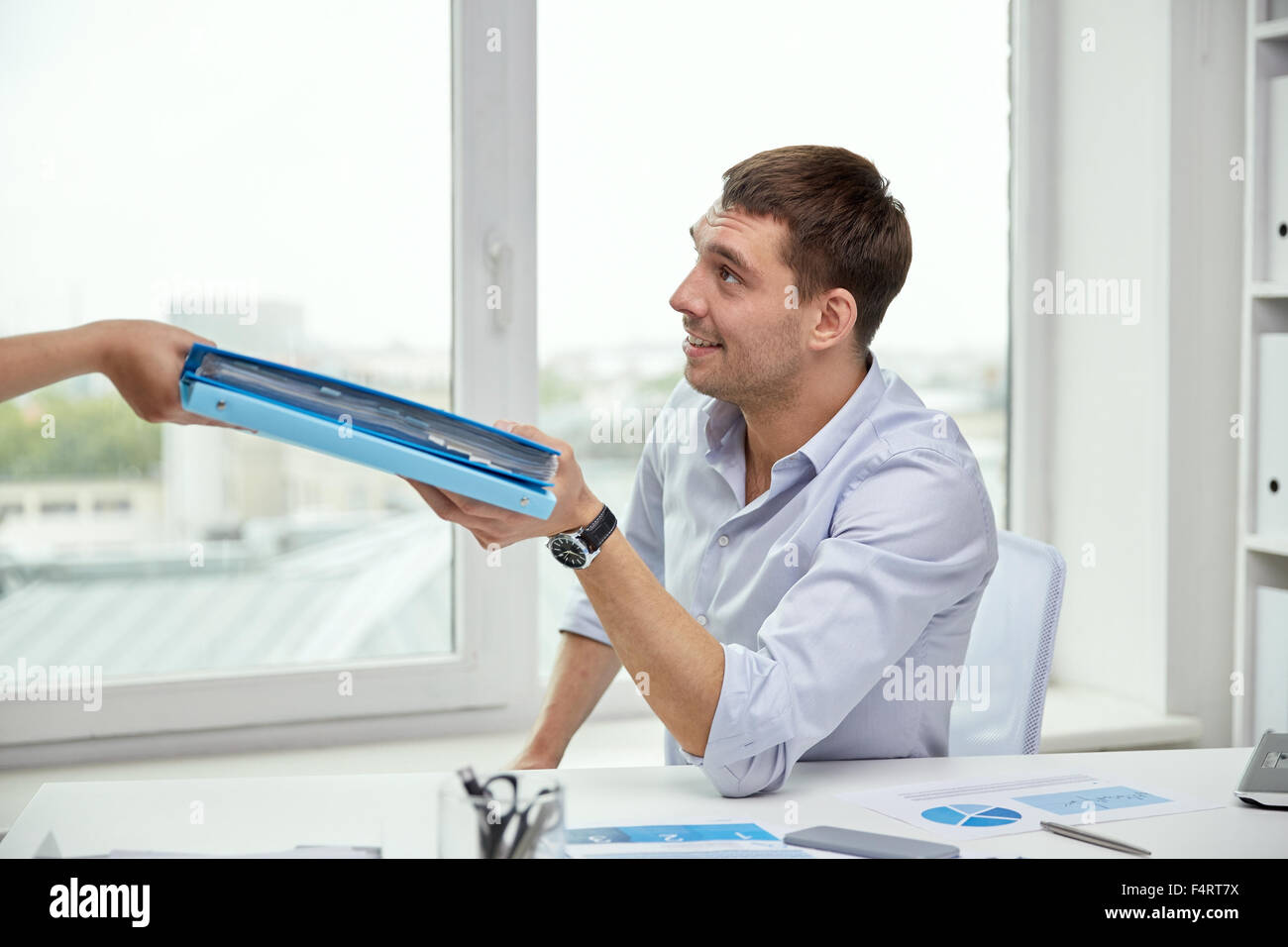 businessman taking papers from secretary in office Stock Photo - Alamy