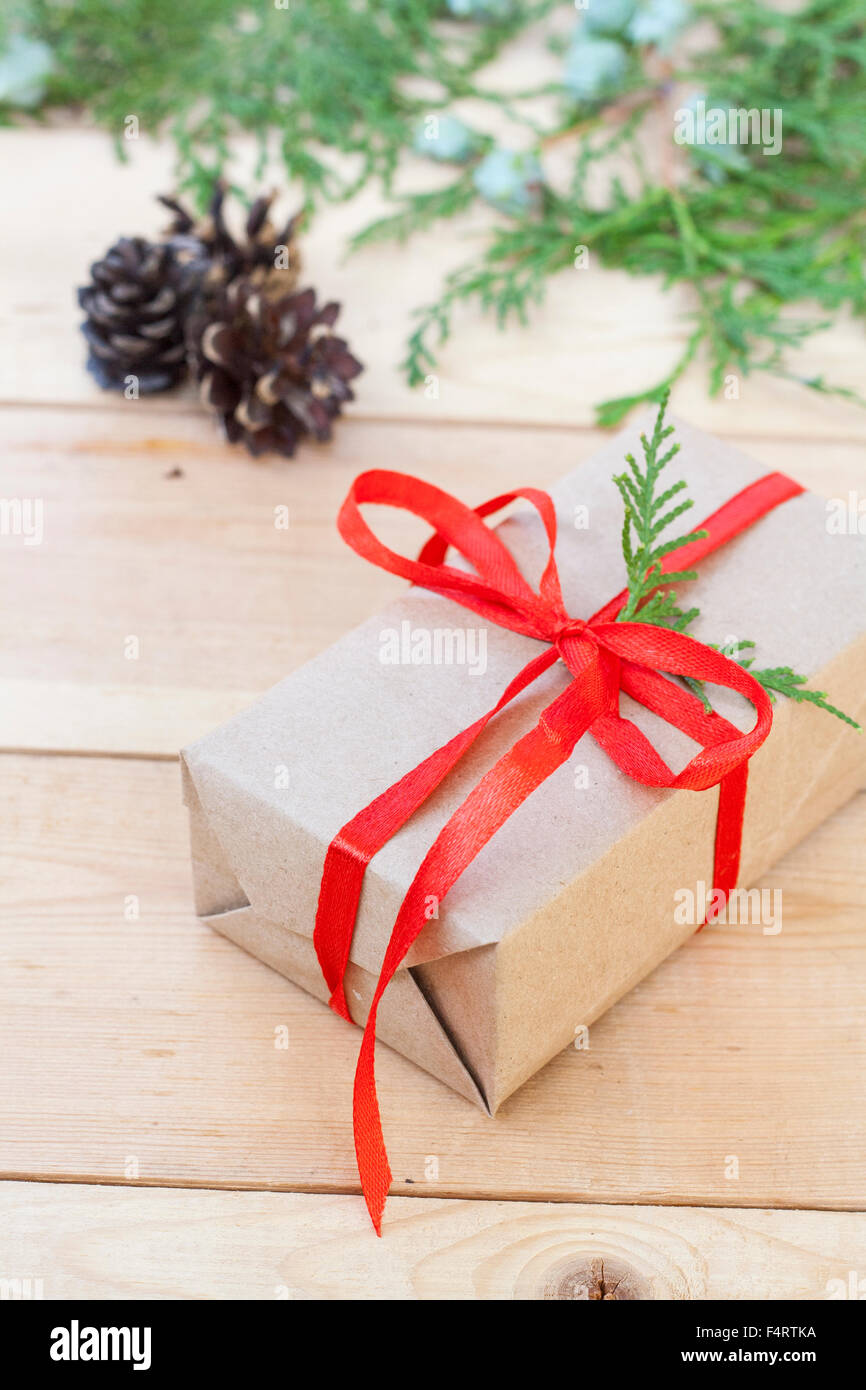 Christmas Gift, nuts, cones and green arborvitae branch on a wooden ...