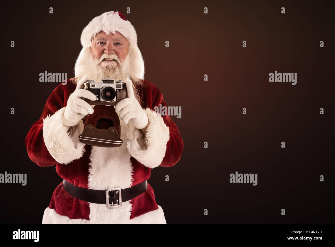 Composite image of santa is taking a picture Stock Photo - Alamy