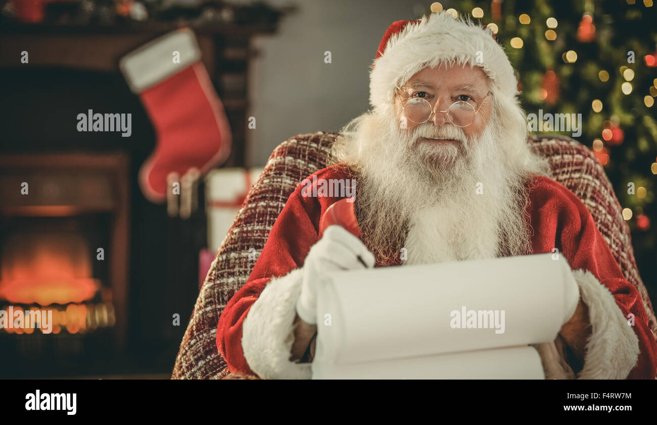 Happy santa writing list with a quill Stock Photo - Alamy