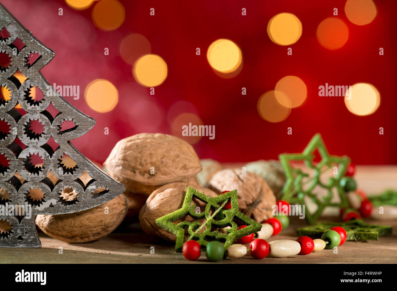 Christmas tree with walnuts and decorations on the red background Stock ...