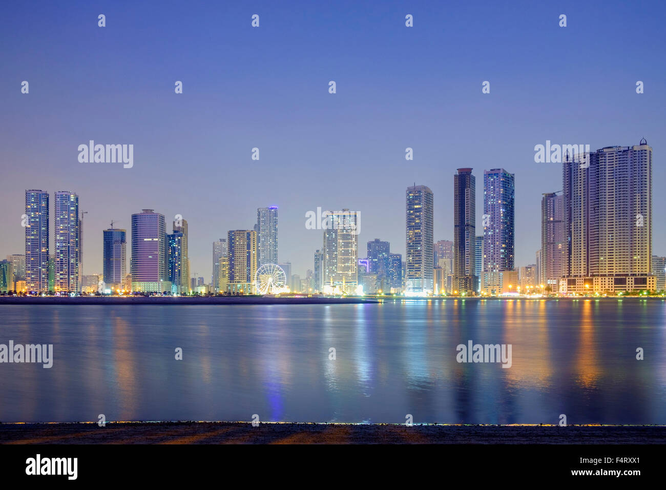 Night skyline view of modern high-rise apartment buildings along ...